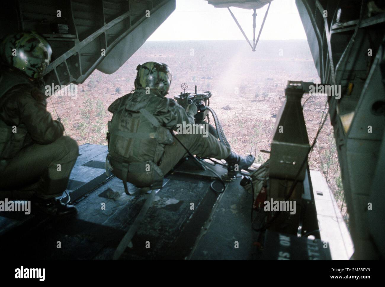 A member of the 20th Special Operations Squadron fires an M-134 7.62mm ...