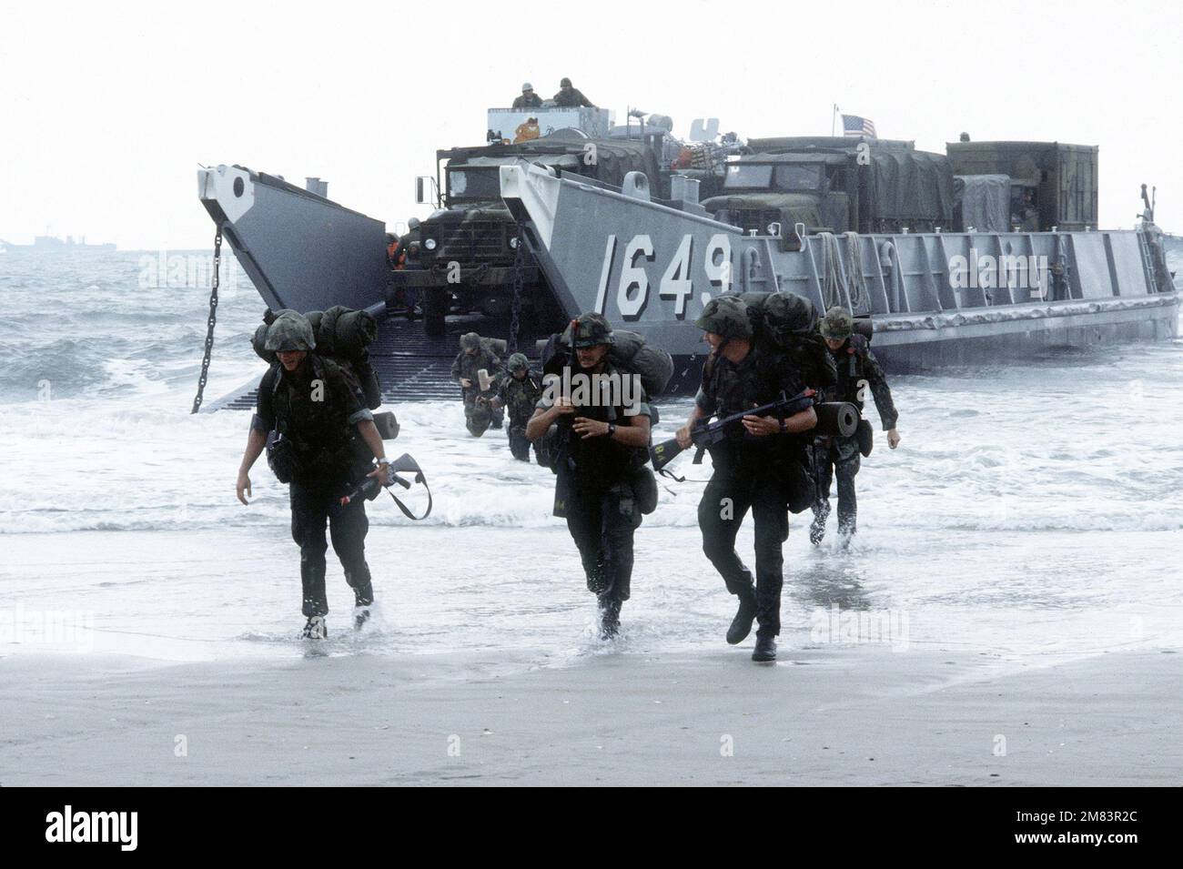 Marines exit from the utility landing craft LCU-1649 at Onslow Beach ...