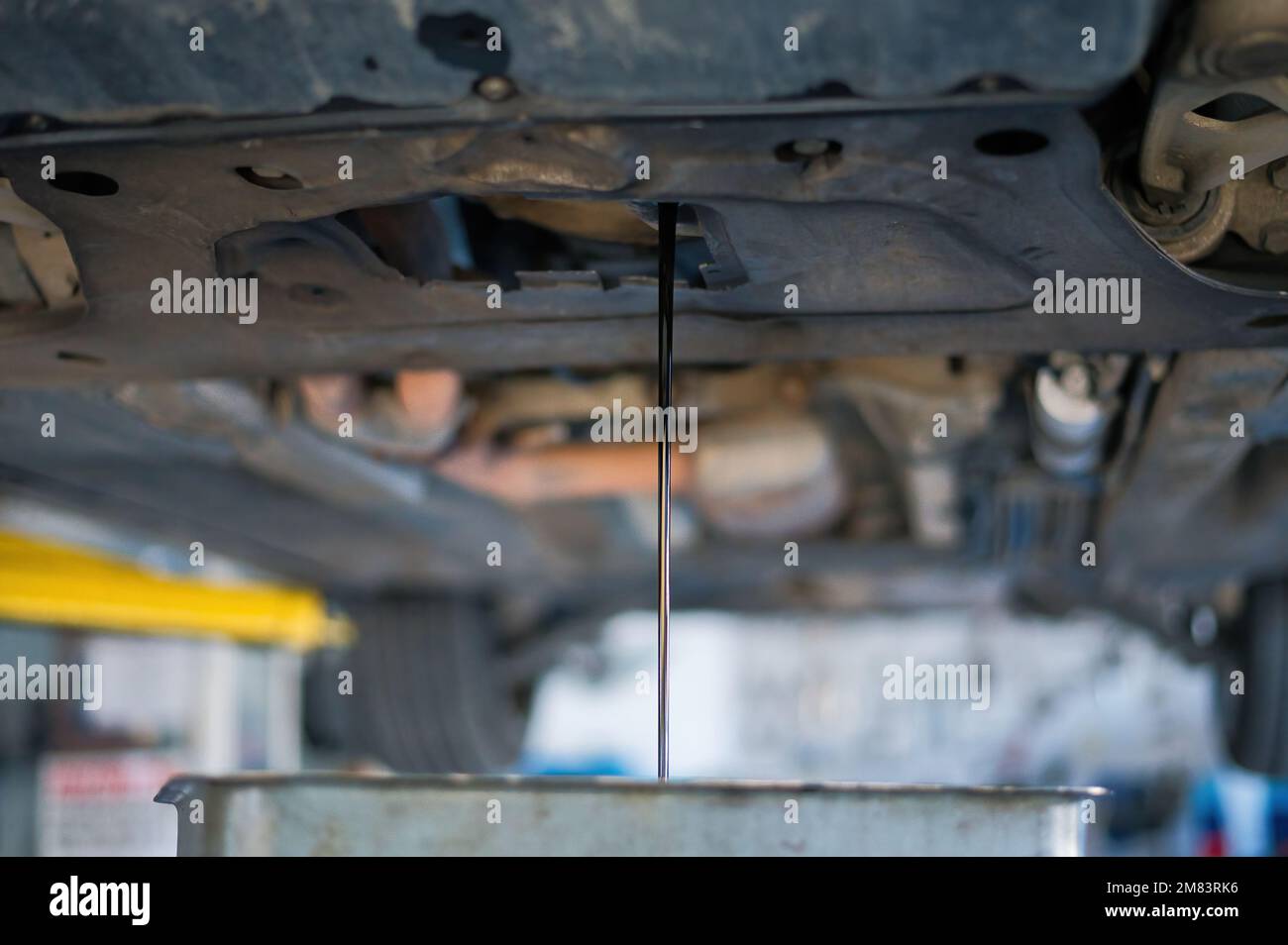 work in a garage , worker controls and changes the motoroil Stock Photo ...