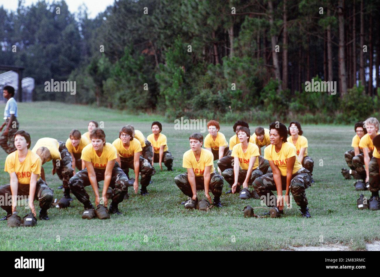 Women Marine recruits stretch in preparation for a physical training ...