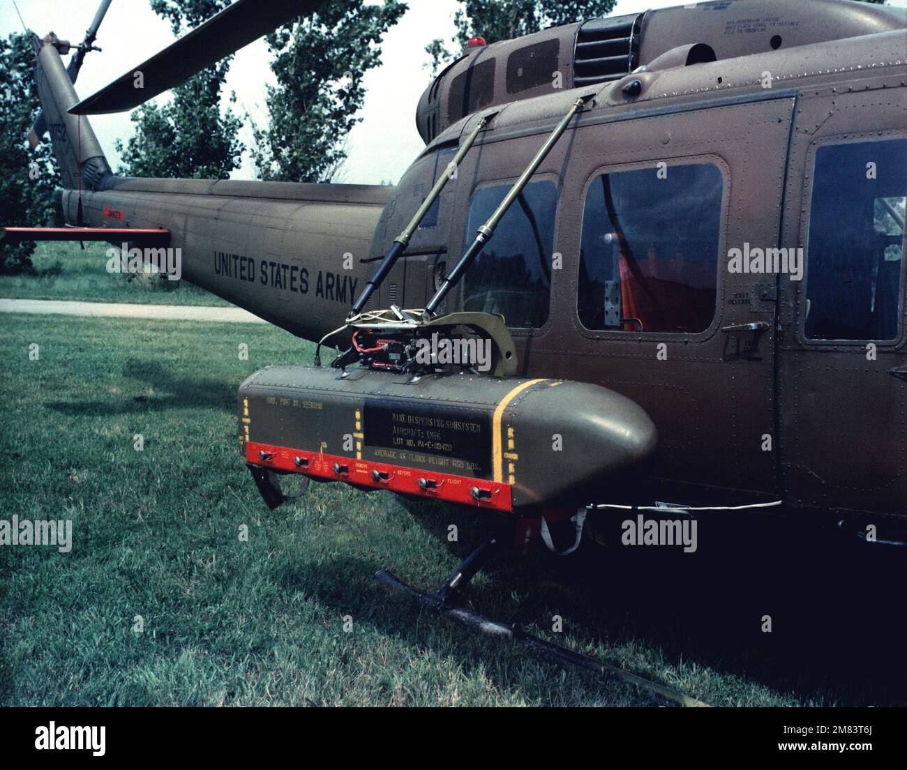A side view of a M-56 heliborne mine-dispensing system attached to a UH ...