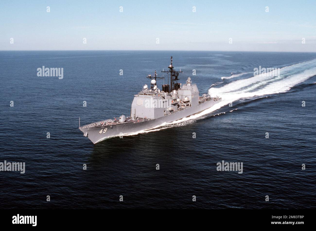 An aerial port bow view of the Ticonderoga class Aegis guided missile ...