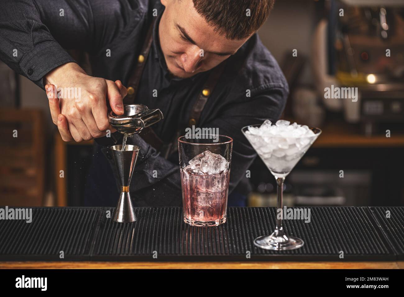 Professional barman at bar making cocktail drinks Stock Photo - Alamy