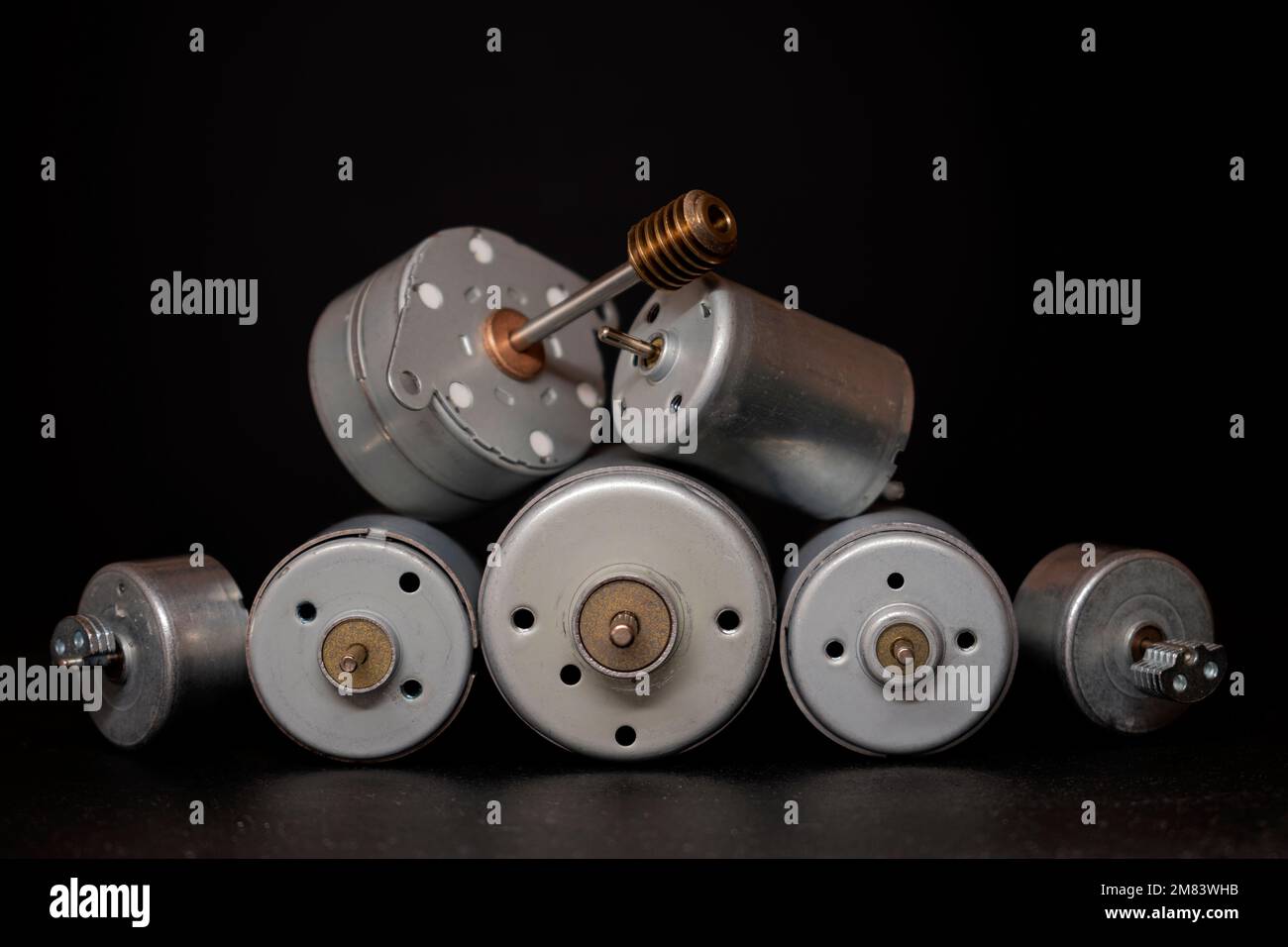 Various dc electric motors on black background Stock Photo - Alamy
