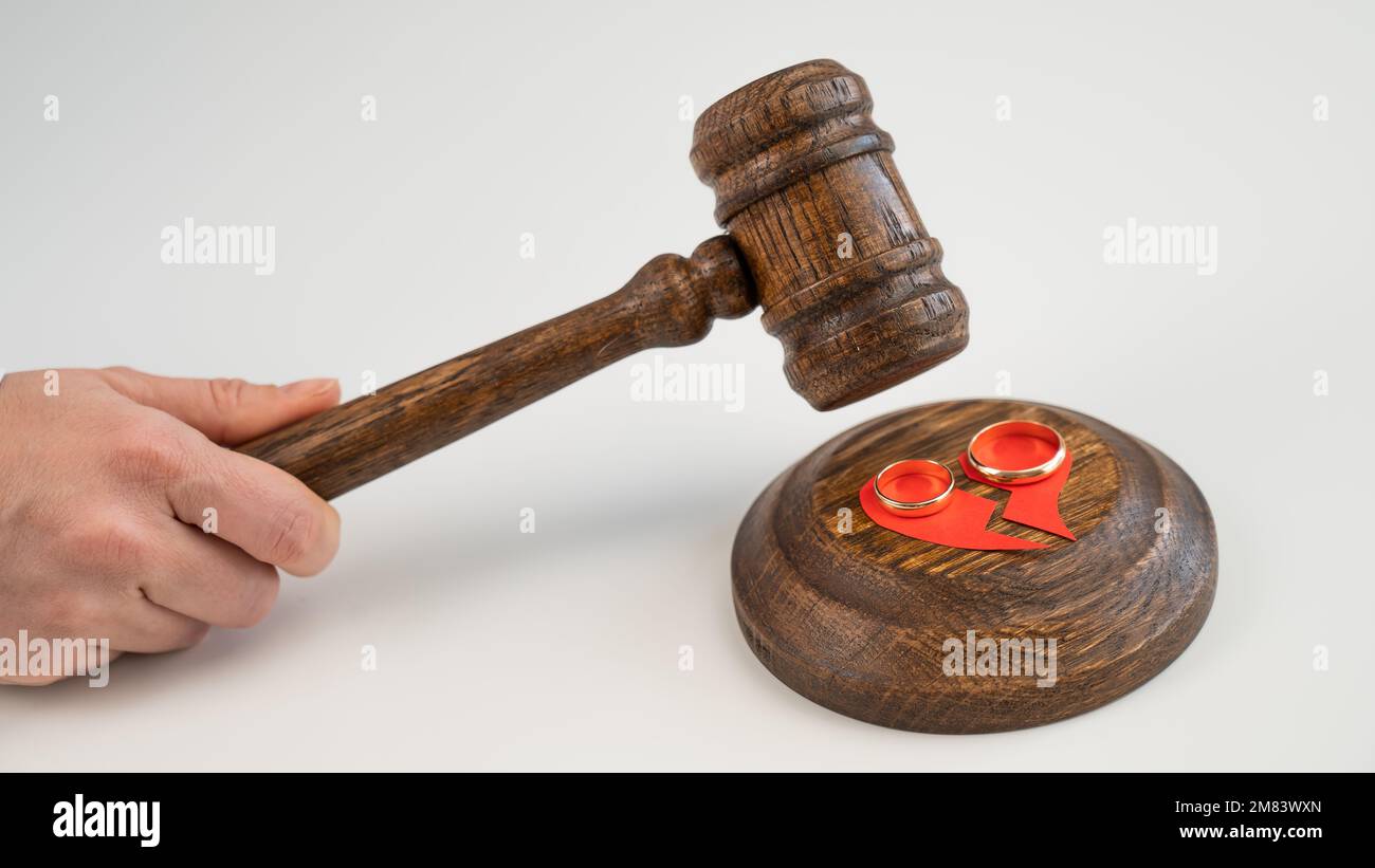 The judge hits the gavel on a broken heart and wedding rings Stock ...