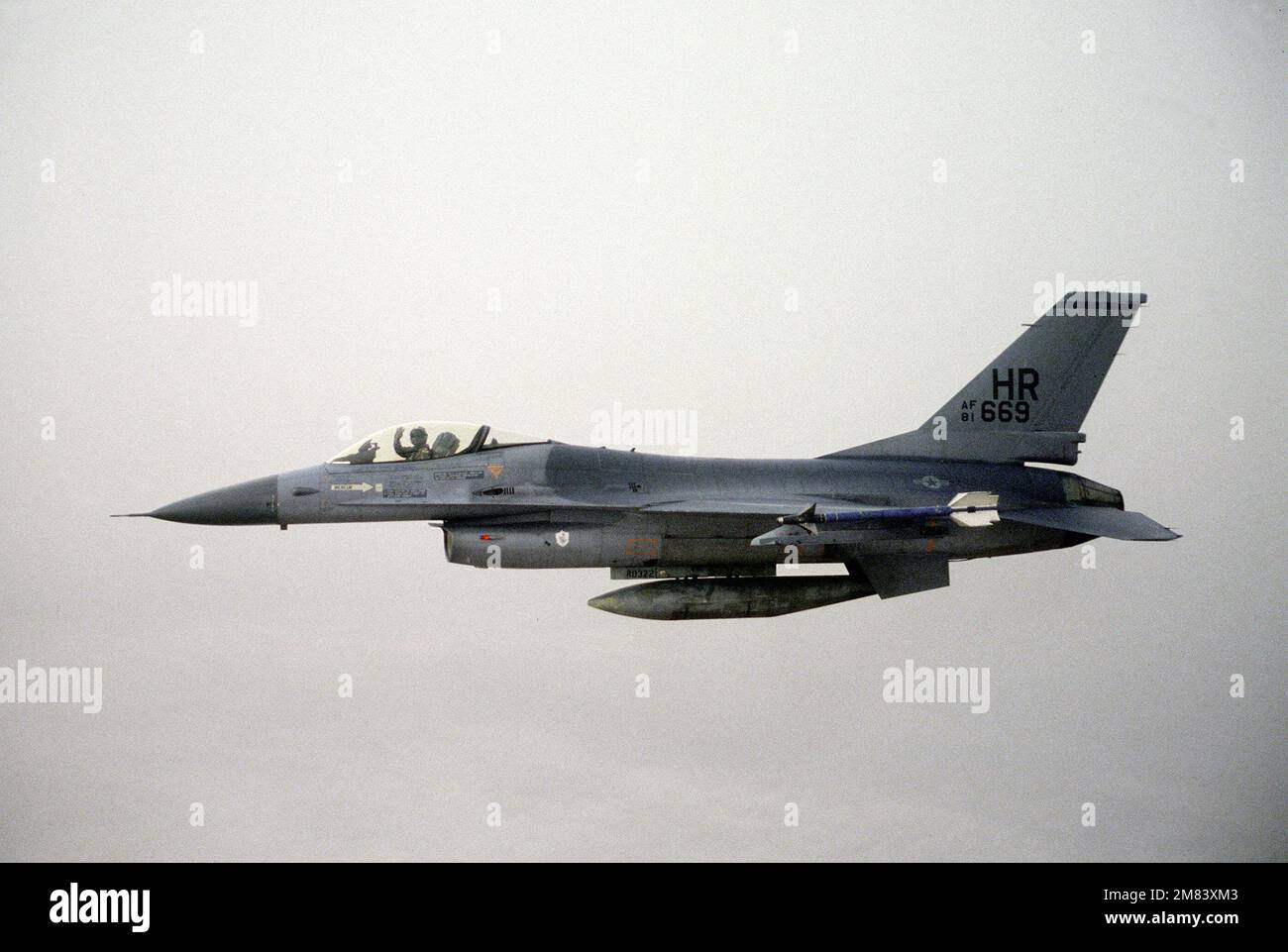 An air-to-air left side view of a 50th Tactical Fighter Wing F-16A ...
