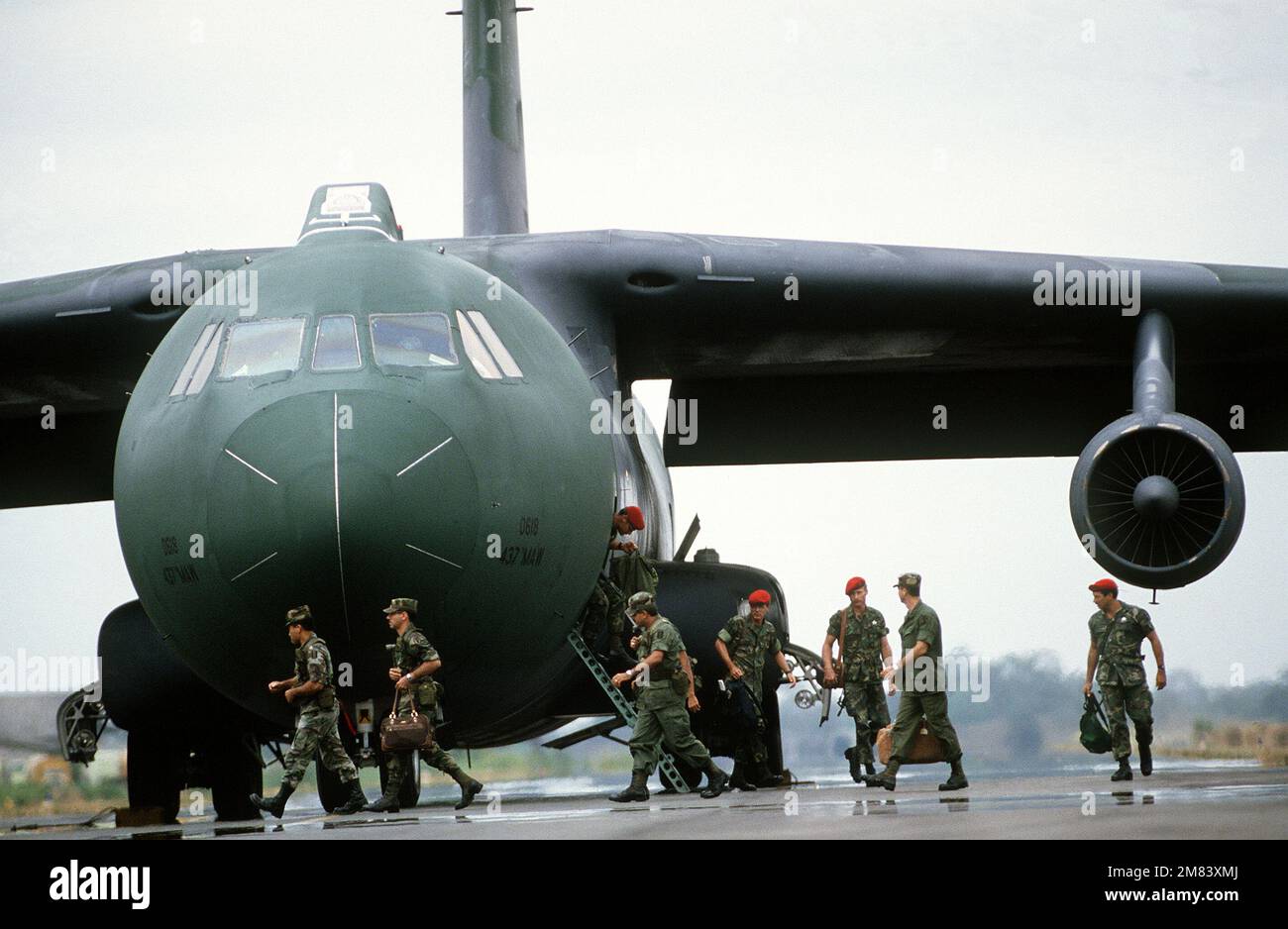 U.S. Army troops exit from a 437th Military Airlift Wing C-141B ...