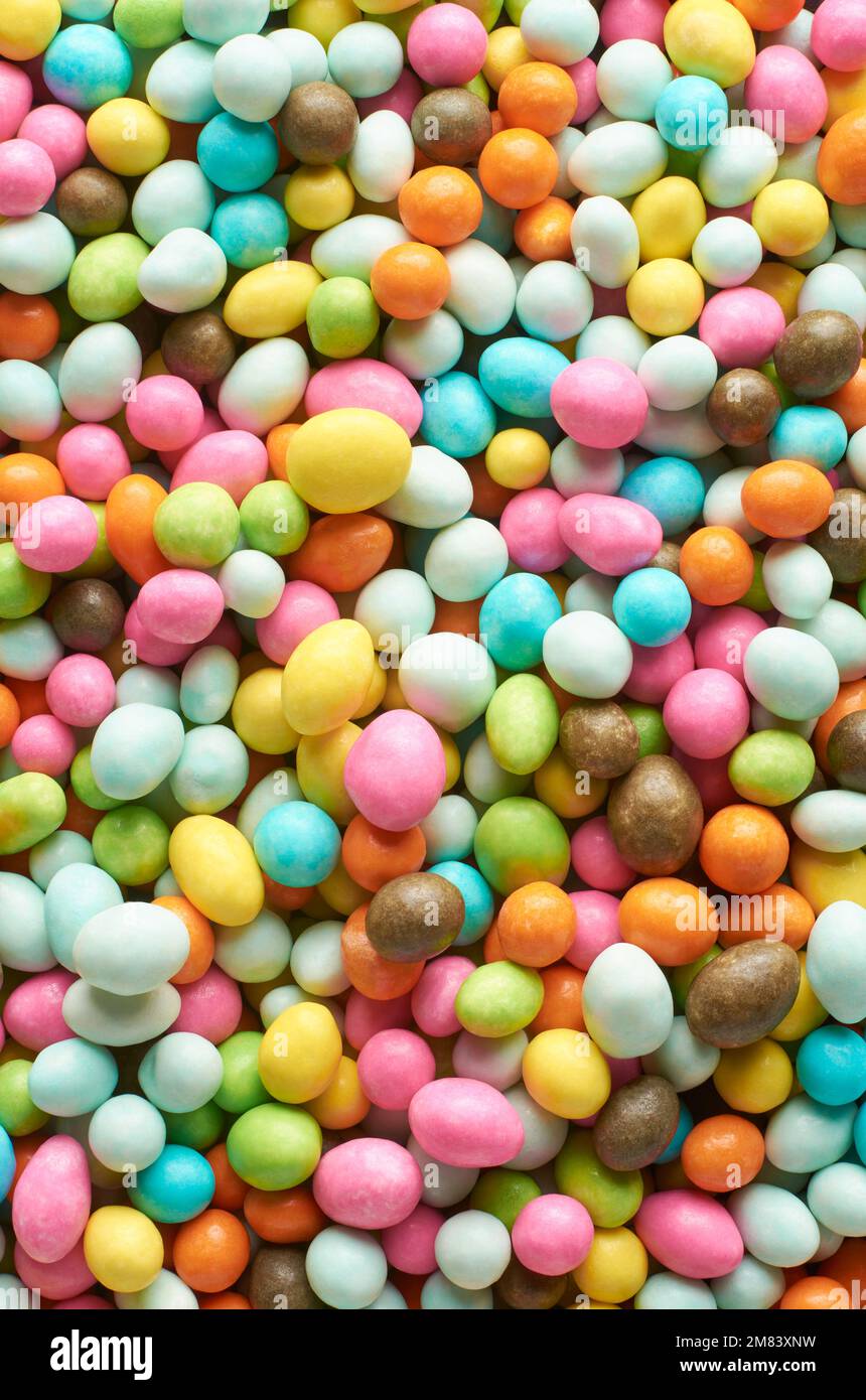 close-up view of colorful sweet balls, multicolor sugary candy in full ...