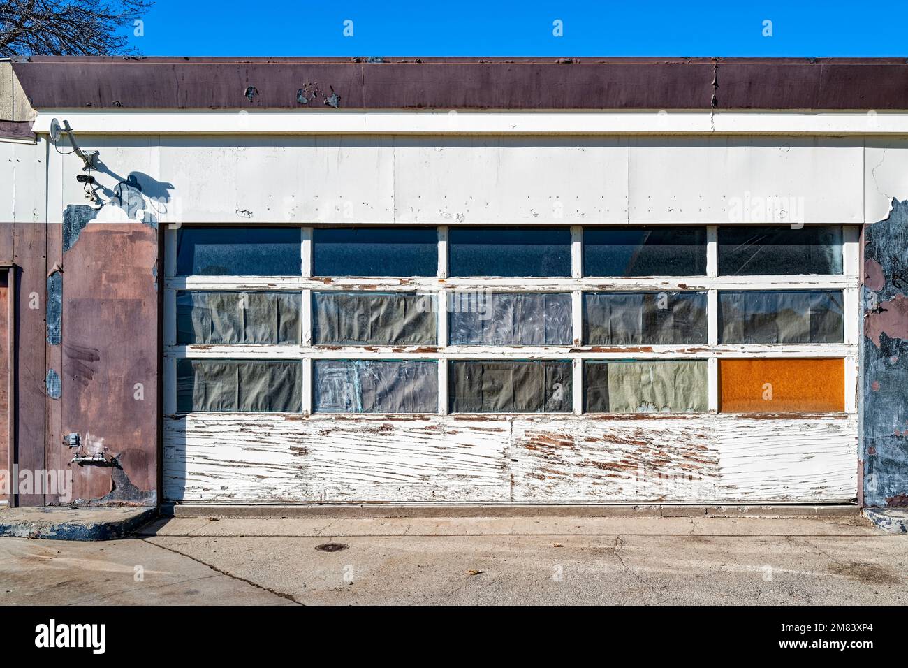 Garage door on the front of a defunct gas station Stock Photo - Alamy