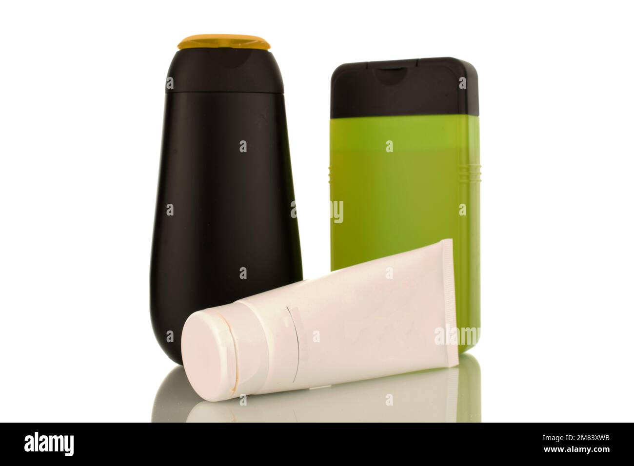 One cosmetic cream and two shampoos in plastic containers, macro ...