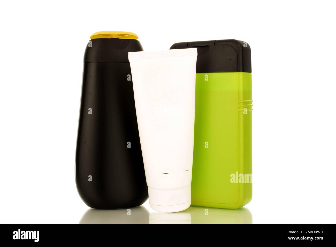 One cosmetic cream and two shampoos in plastic containers, macro ...