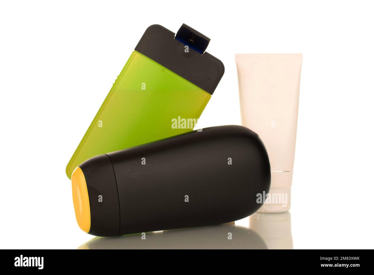 One cosmetic cream and two shampoos in plastic containers, macro ...