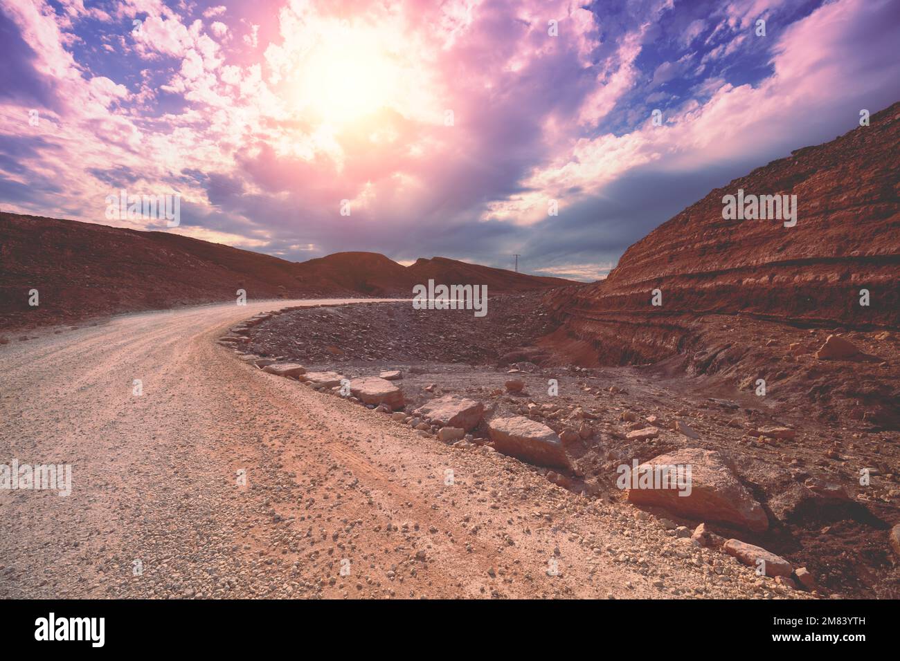 Mountain desert landscape. Dirt road in National Park Makhtesh Ramon ...