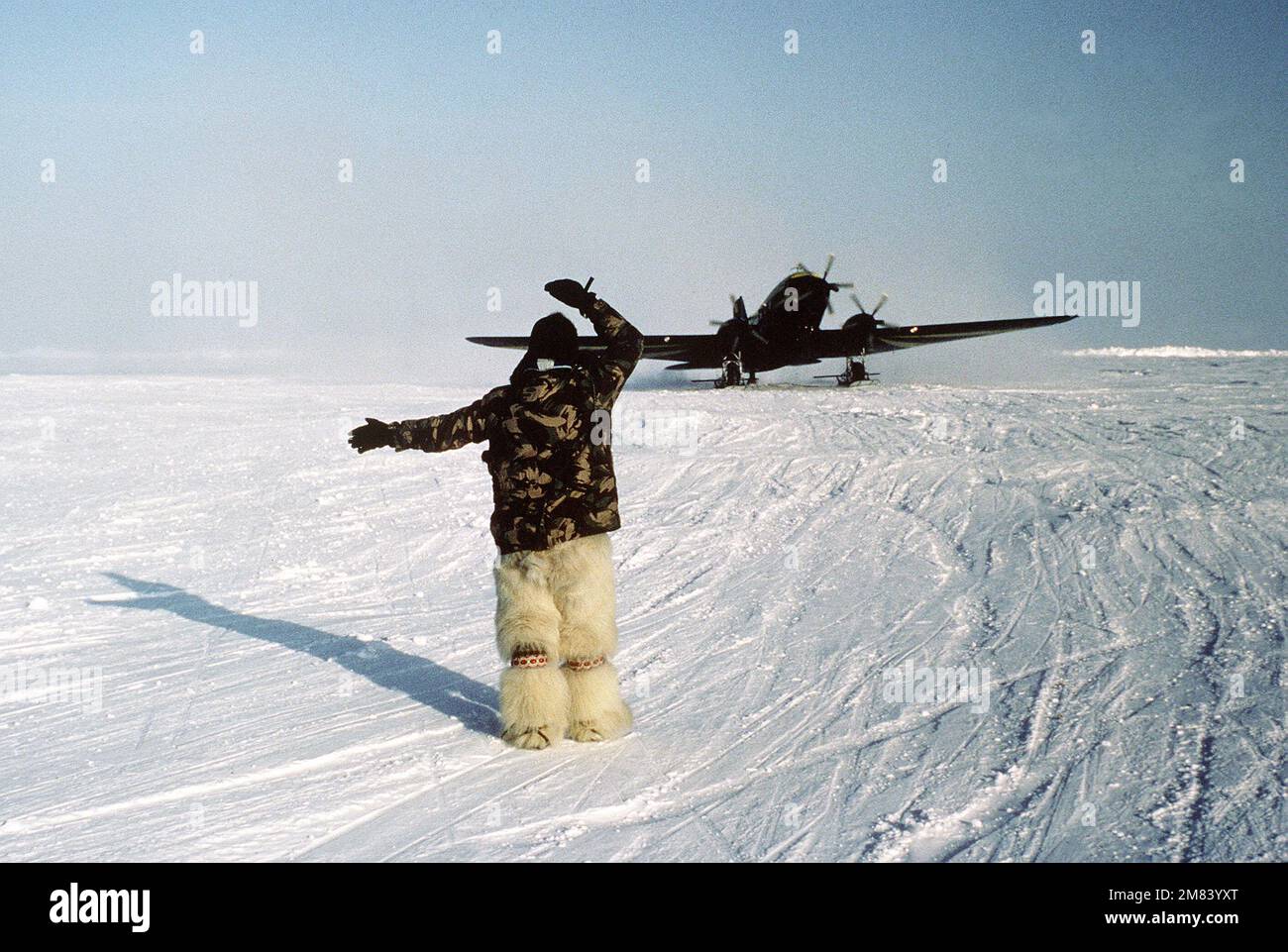 A member of an arctic research station directs a converted DC-3 ...