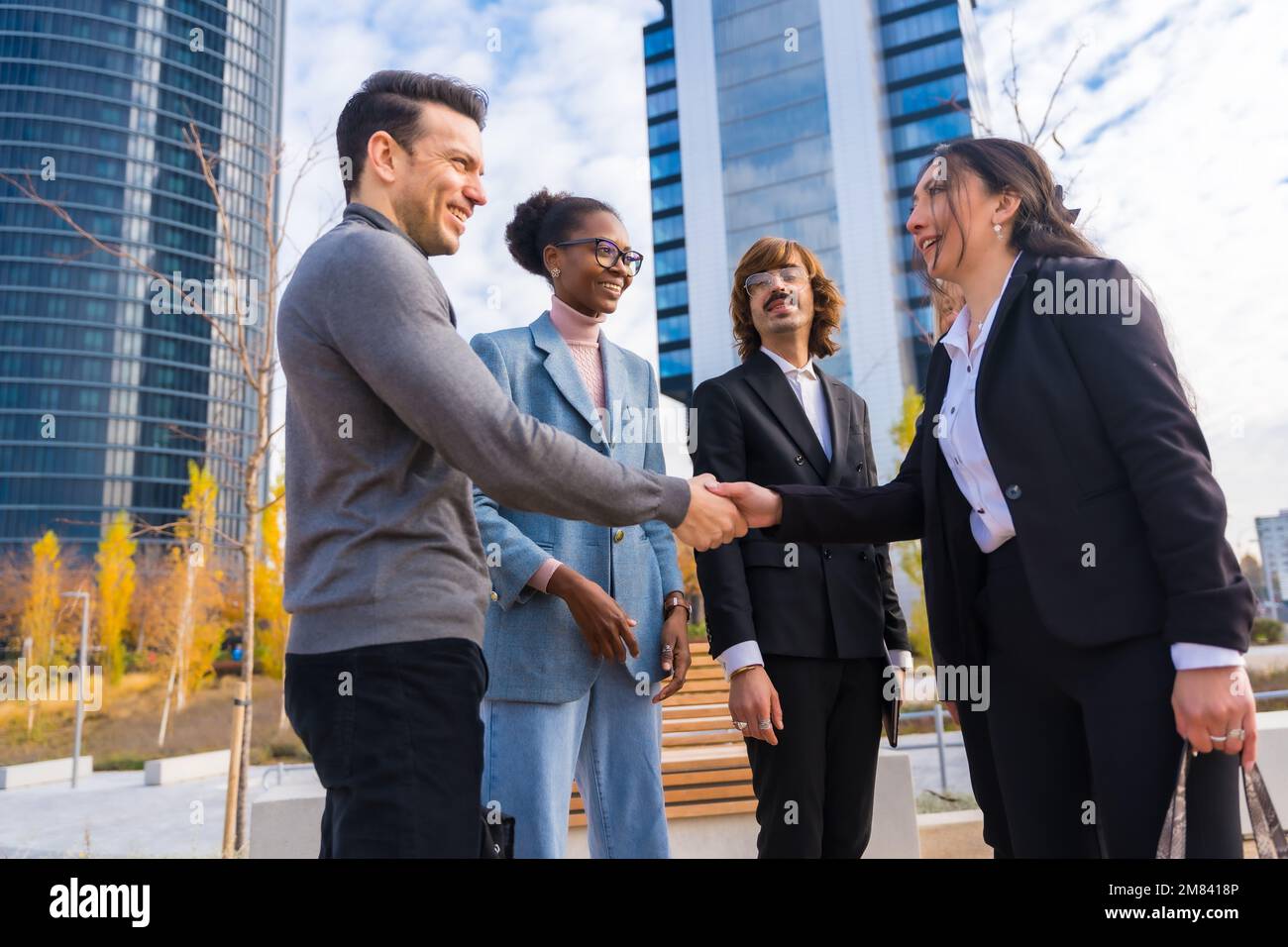 A group of multi-ethnic fellow businessmen or executives introducing ...