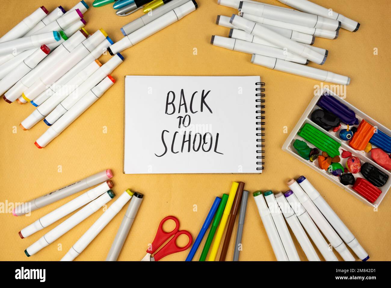 Many different office supplies. School markers, pens and plasticine ...