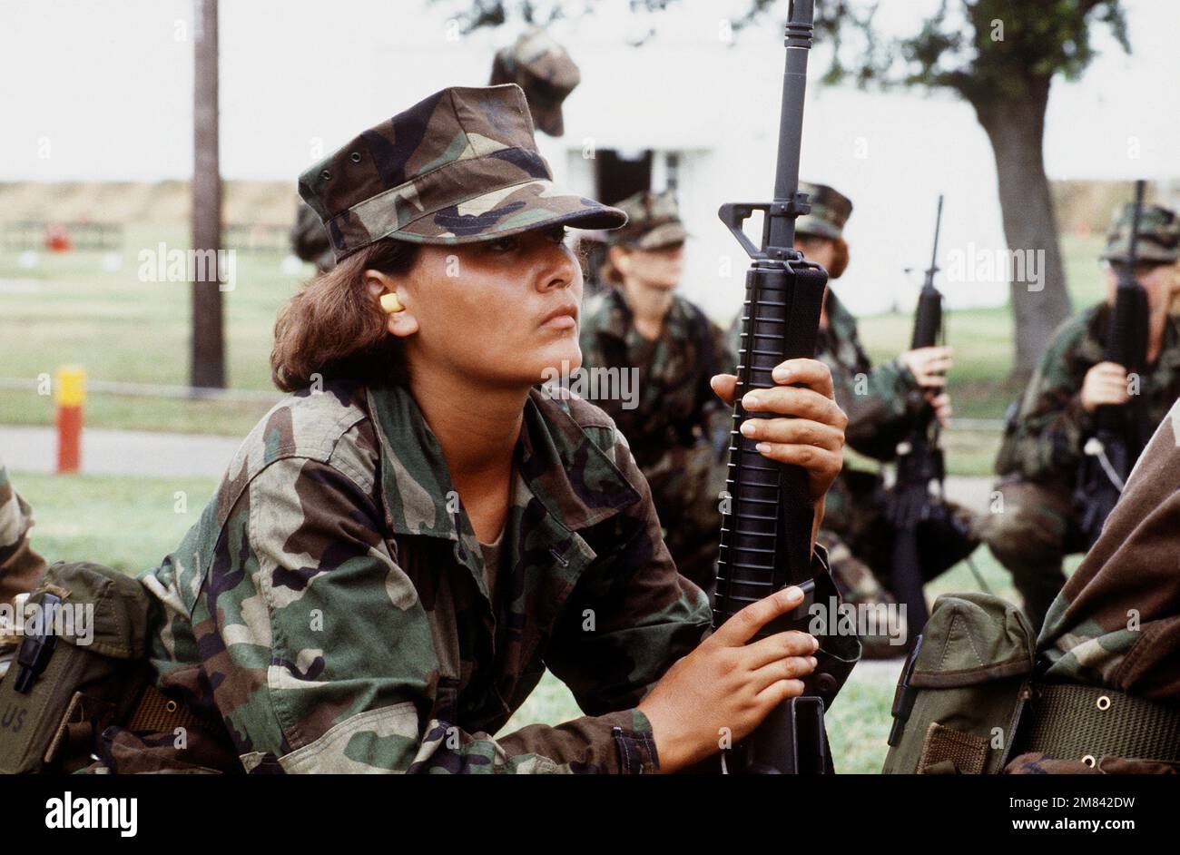 A woman Marine recruit waits to fire an M-16A2 rifle during basic ...