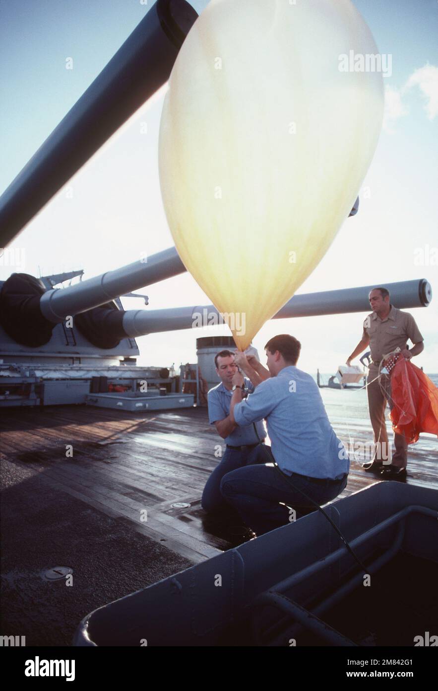 Aerographers inflate a weather balloon and prepare it for launching ...