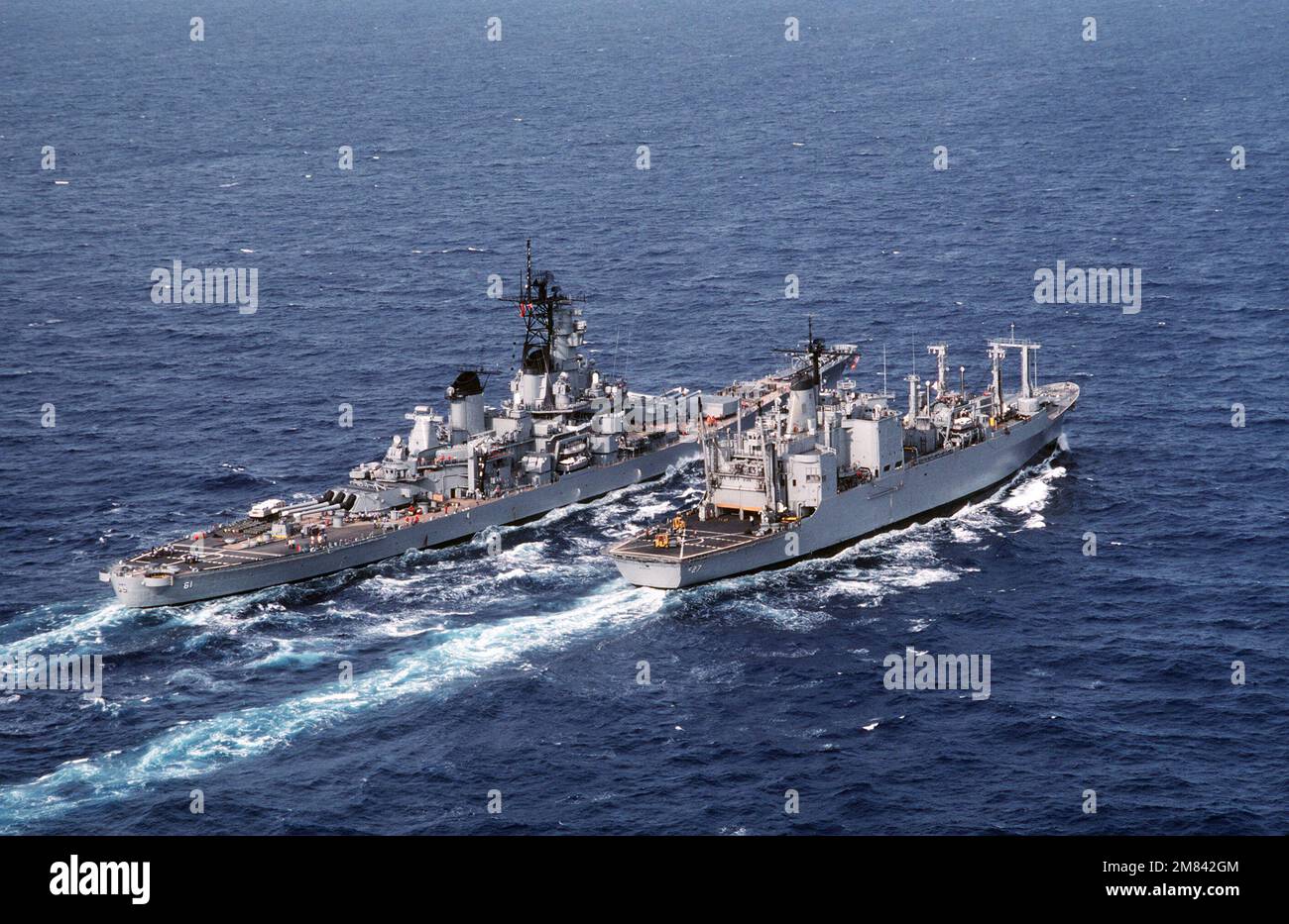 An elevated starboard quarter view of the battleship USS IOWA (BB 61 ...