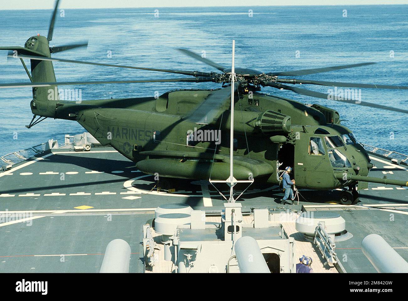 A CH-53E Super Stallion helicopter is parked on the helicopter pad ...