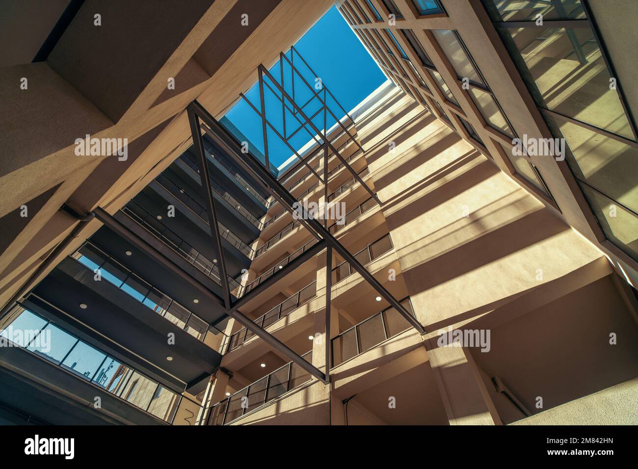 Modern yellow building viewed upwards from the inner courtyard of the ...