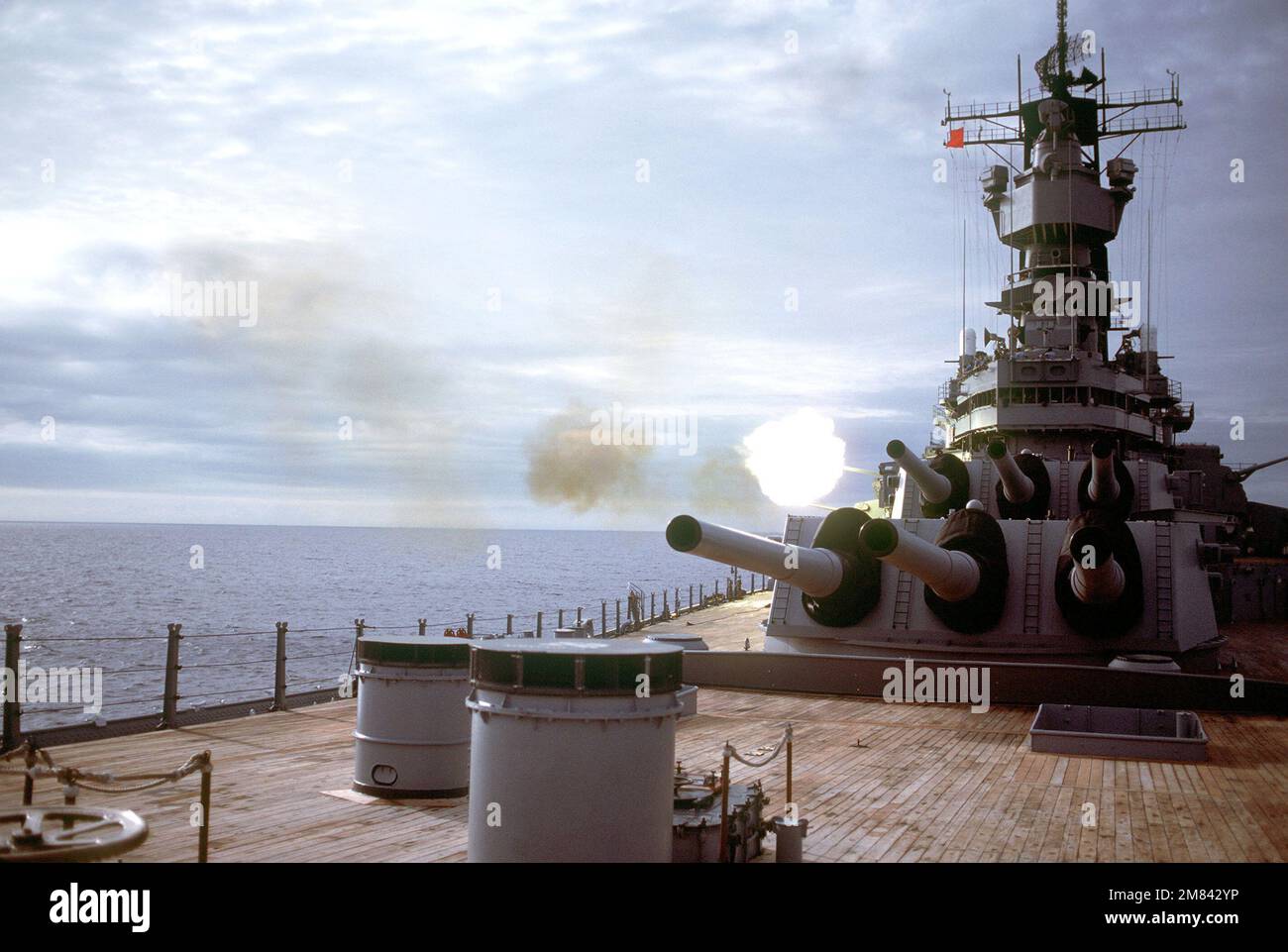A Mk 28 5 in. gun is fired to starboard aboard the battleship USS IOWA ...