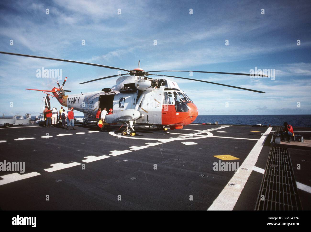 A SH-3A Sea King helicopter is serviced during flight operations aboard ...