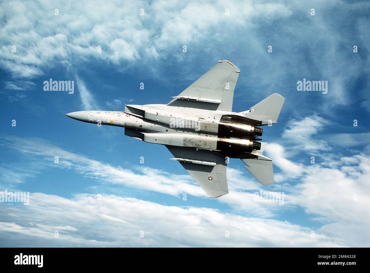 An air-to-air underside view of an F-15 Eagle test bed aircraft ...