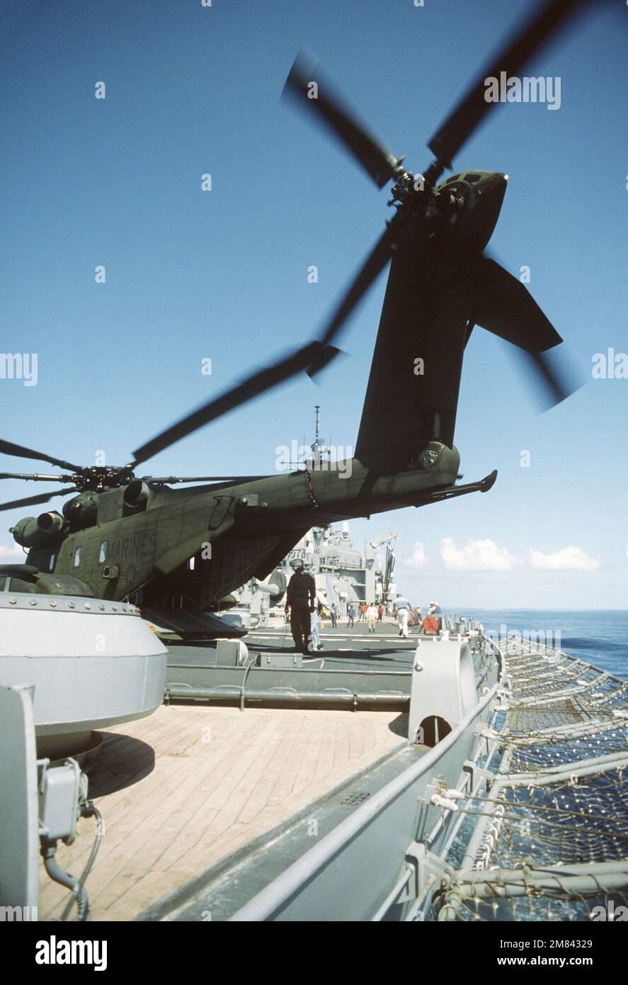 A CH-53E Super Stallion helicopter is parked on the helicopter pad ...