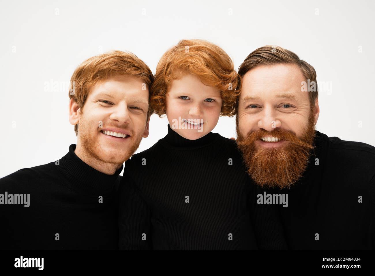 cheerful red haired boy with bearded grandfather and dad in black ...