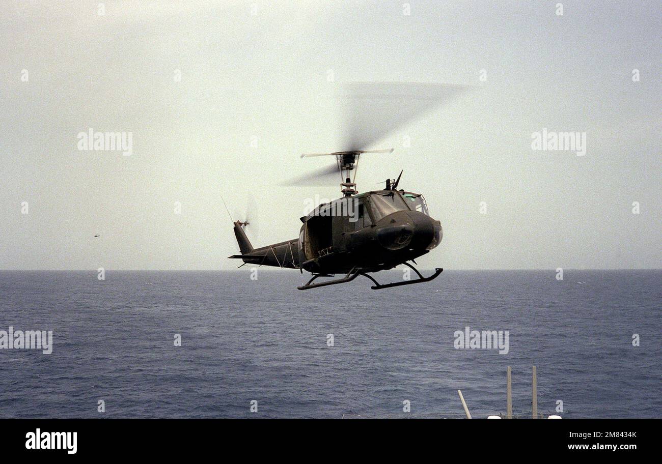 A U.S. Army UH-1H Iroquois helicopter approaches for a landing aboard ...