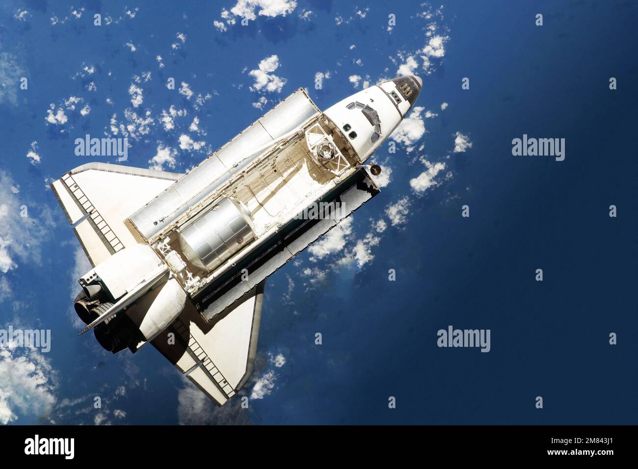 Space shuttle above the surface of the Earth. Elements of this image ...