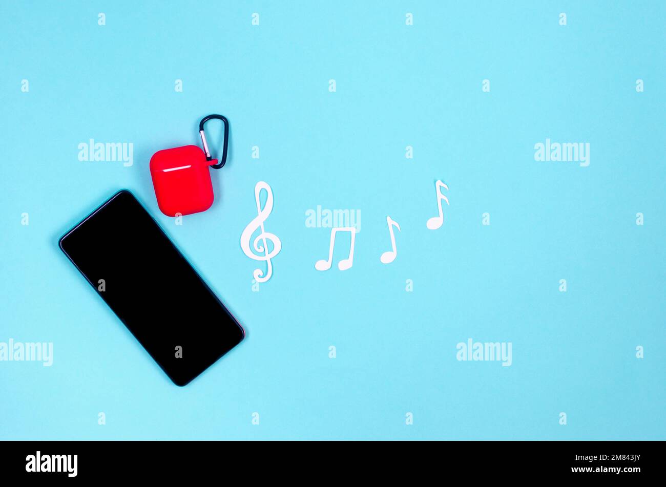 telephone, wireless earphones with paper music notes and treble clef on ...