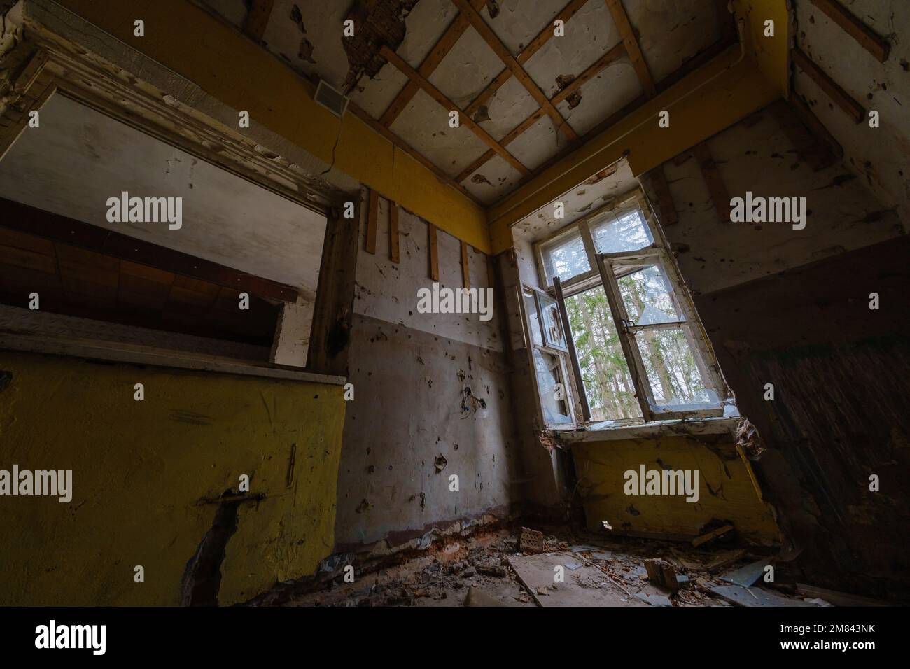 Interior of shabby room of desolate building with crumbling brick walls ...
