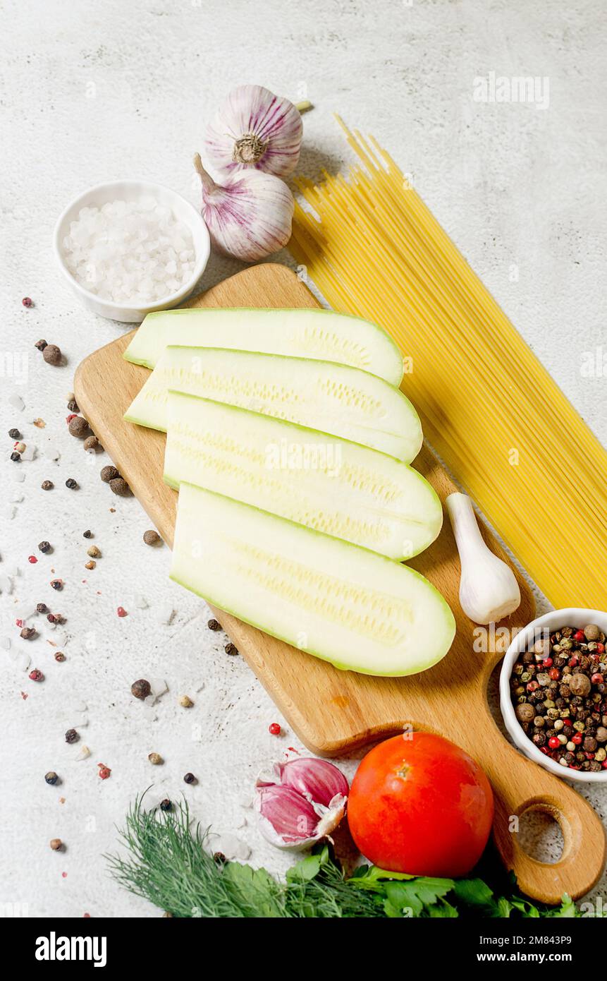Raw long spaghetti with ingredients for cooking, marrow, tomatoes ...
