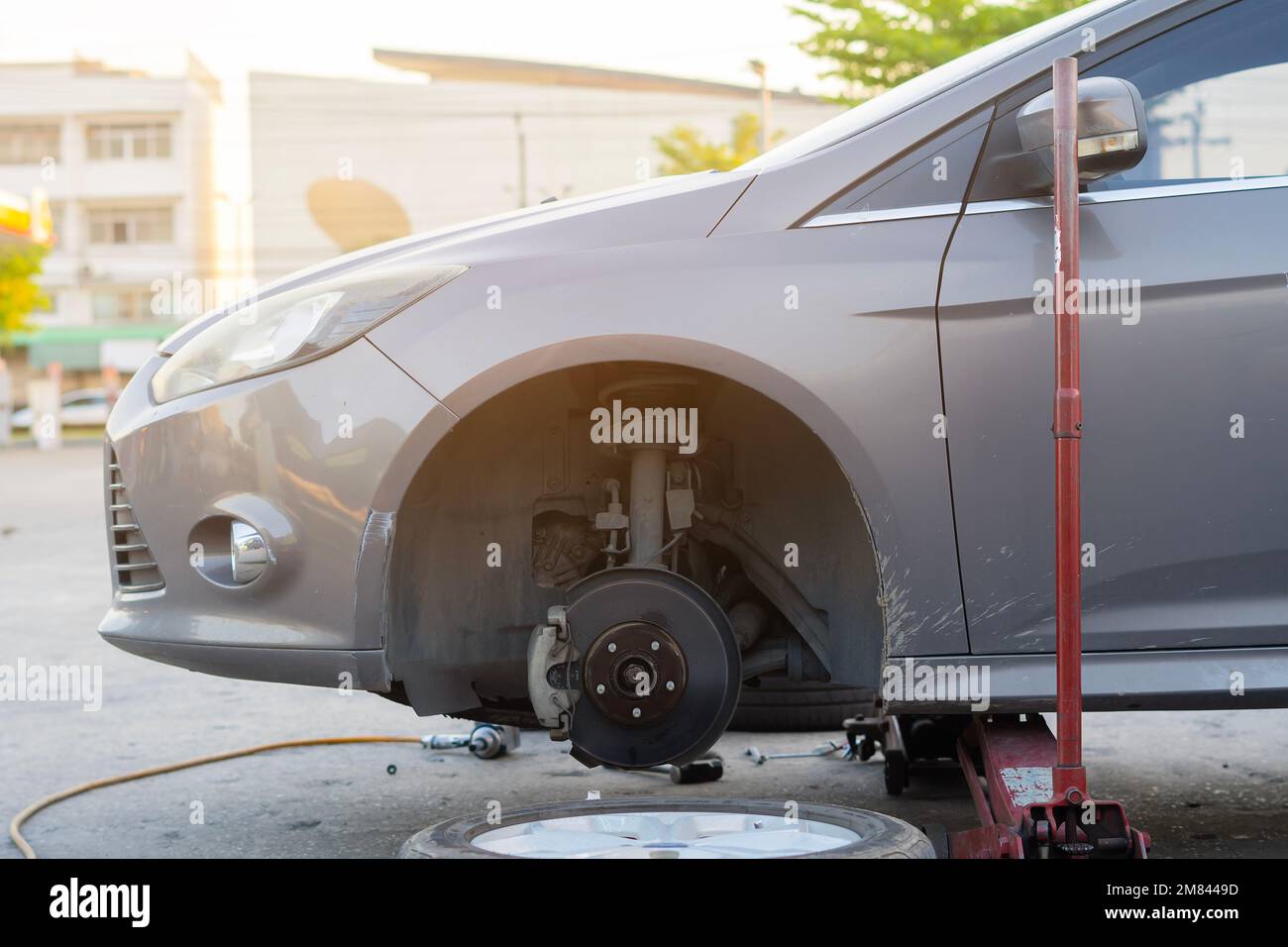 Quick service changing the car wheels with hydraulic floor jack Stock ...