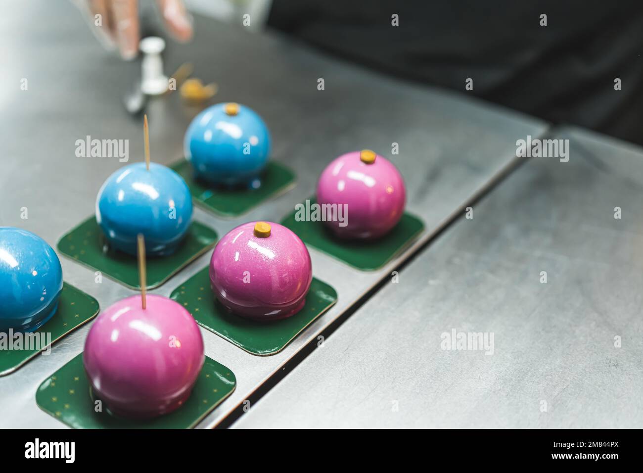 making pink and blue chocolate ball cakes at the bakery, delicious ...