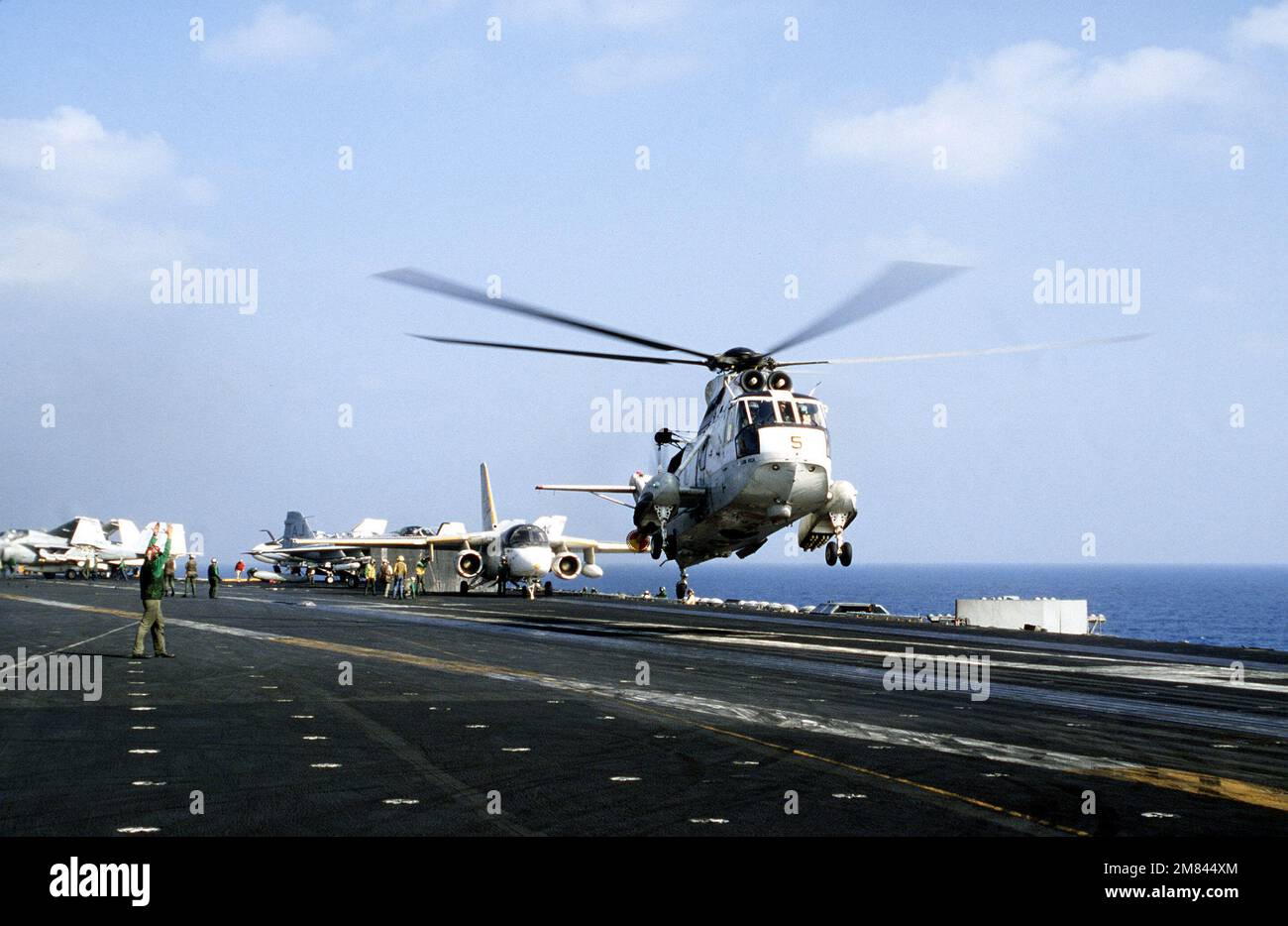 An SH-3 Sea King helicopter takes off from the nuclear-powered aircraft ...