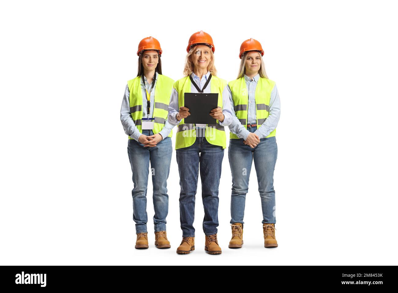 Team of female site engineers with safety vests and hardhats isolated ...