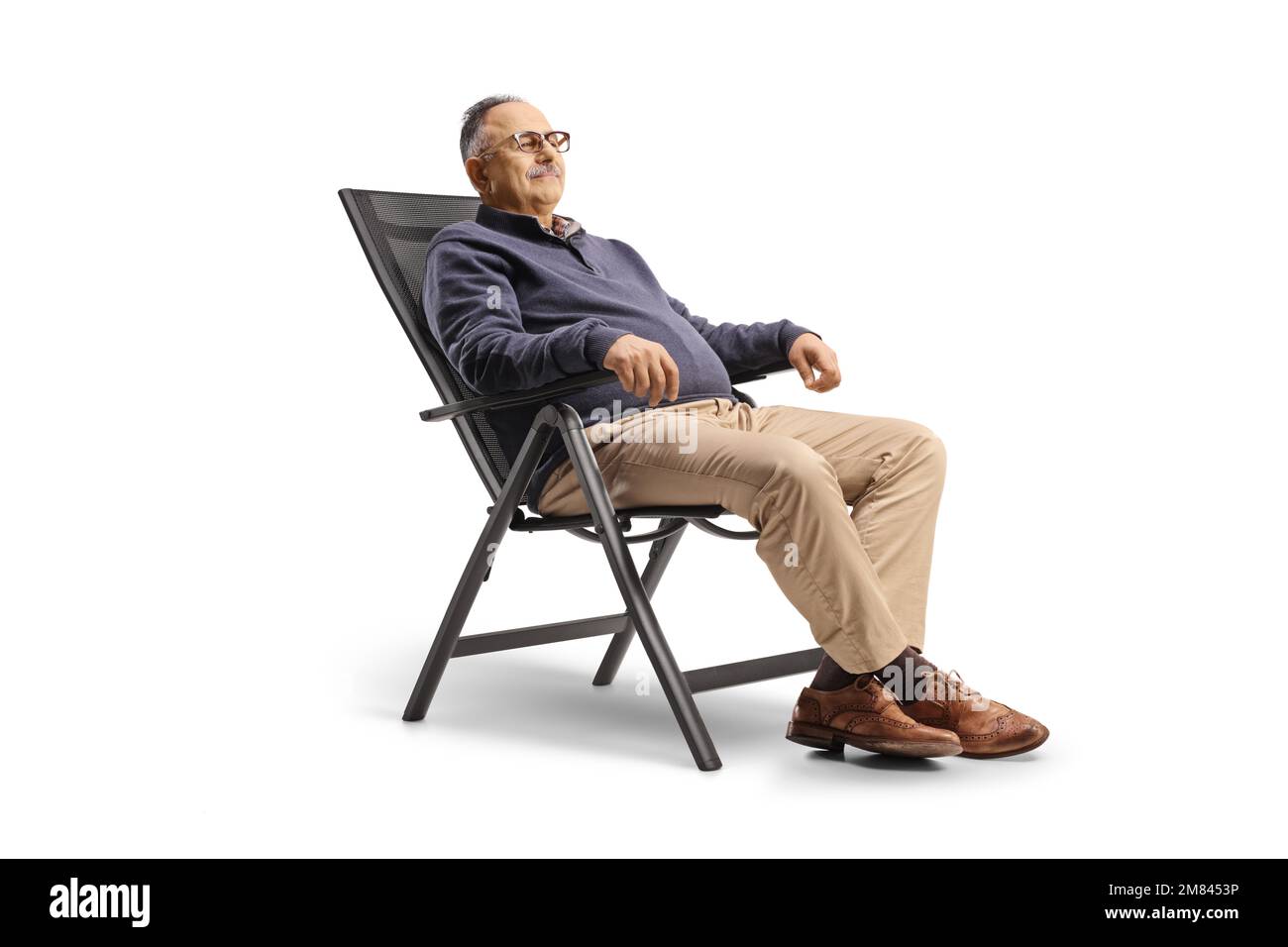 Mature man resting seated in a foldable chair isolated on white ...
