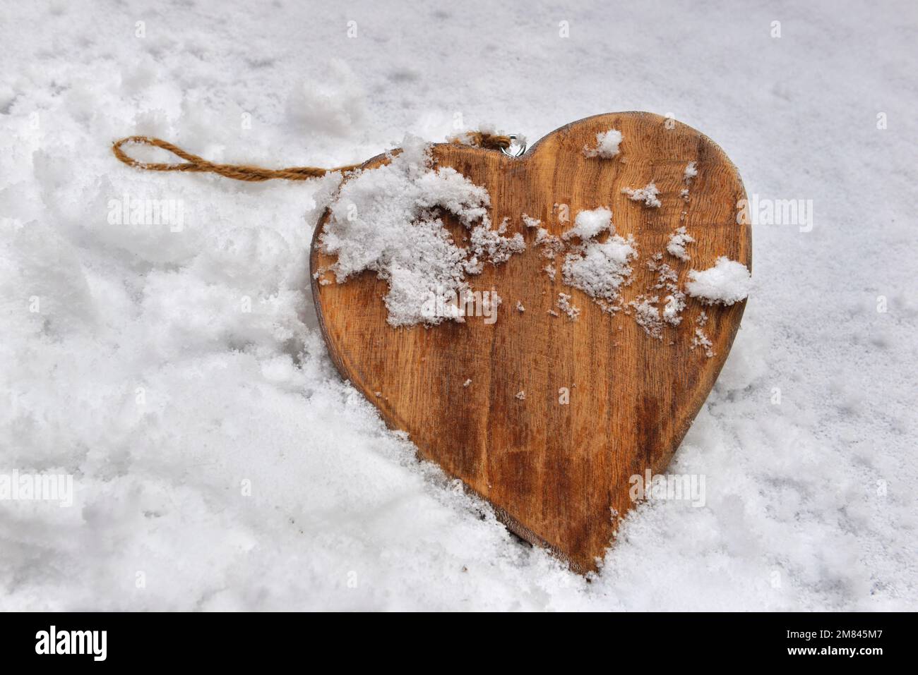 closeup on decorative wooden shape heart in the snow Stock Photo - Alamy