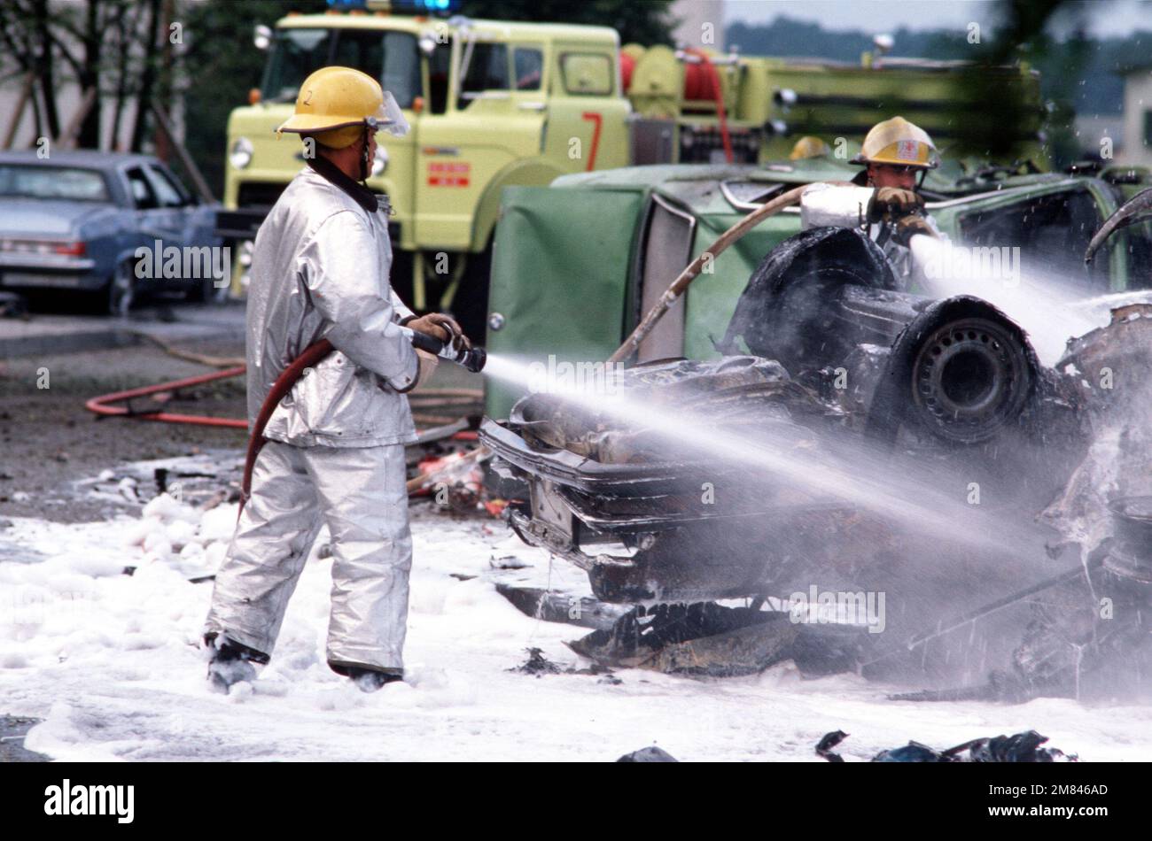 Firefighters extinguish the flames from a car that was loaded with a ...
