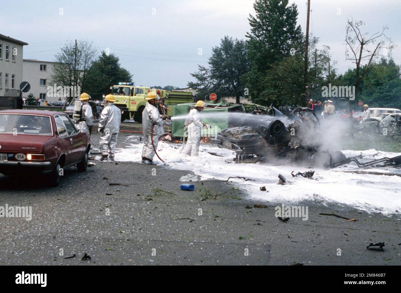 Firefighters extinguish the flames from a car that was loaded with a ...