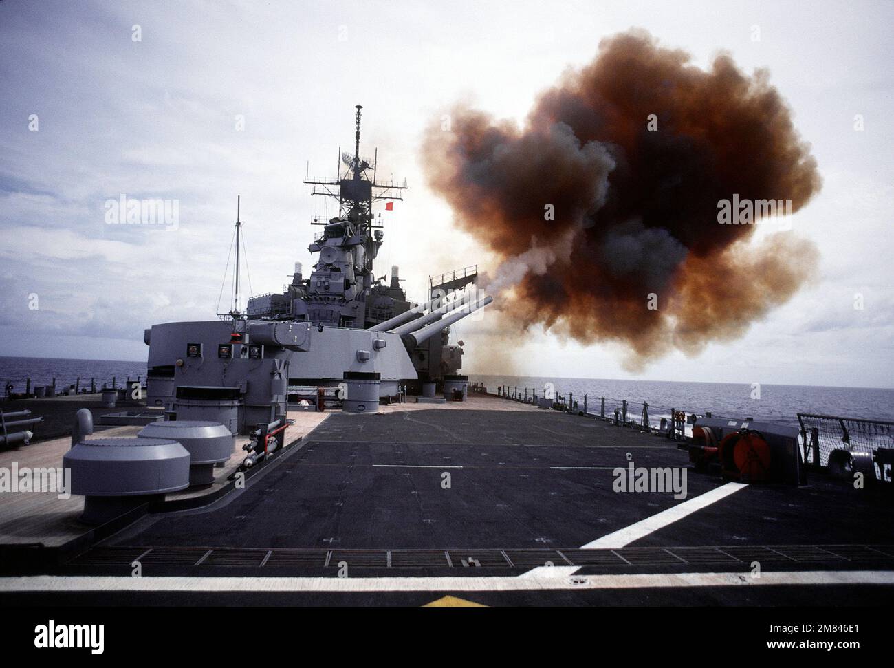 A salvo is fired from the No. 3 Mark 7 16-inch/50 caliber gun turret ...