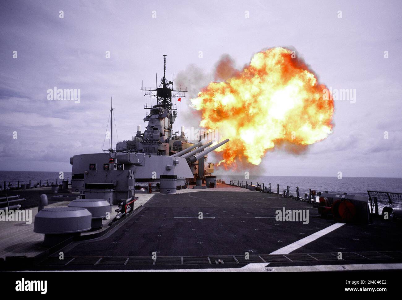 A salvo is fired from the No. 3 Mark 7 16-inch/50 caliber gun turret ...