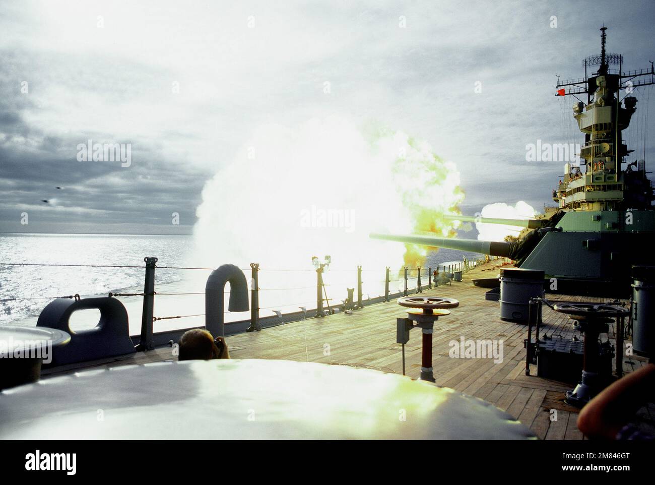 A broadside is fired from the Mark 7 16-inch/50-caliber turrets aboard ...