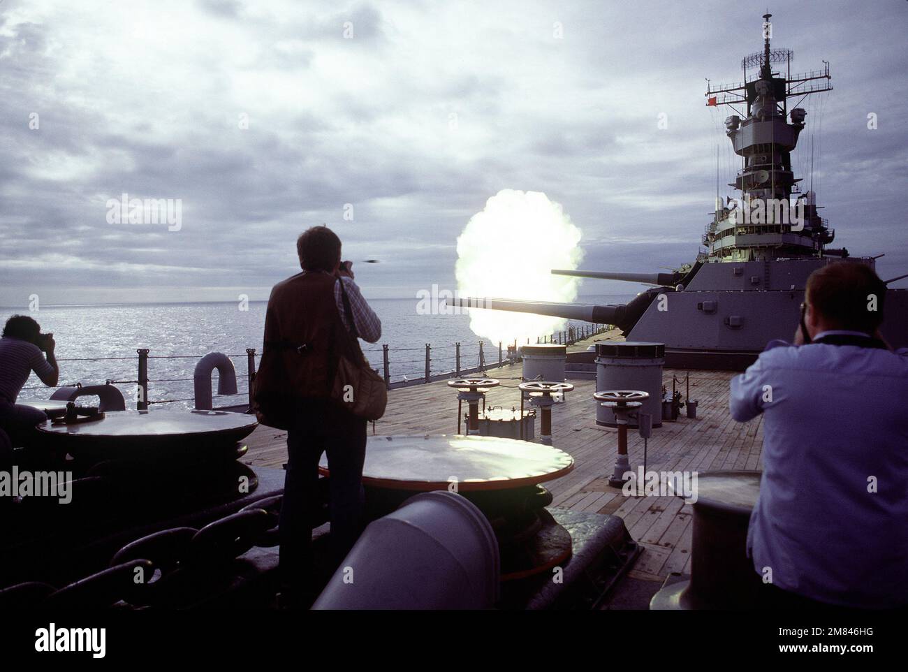 Members of the civilian press record a projectile being fired from the ...