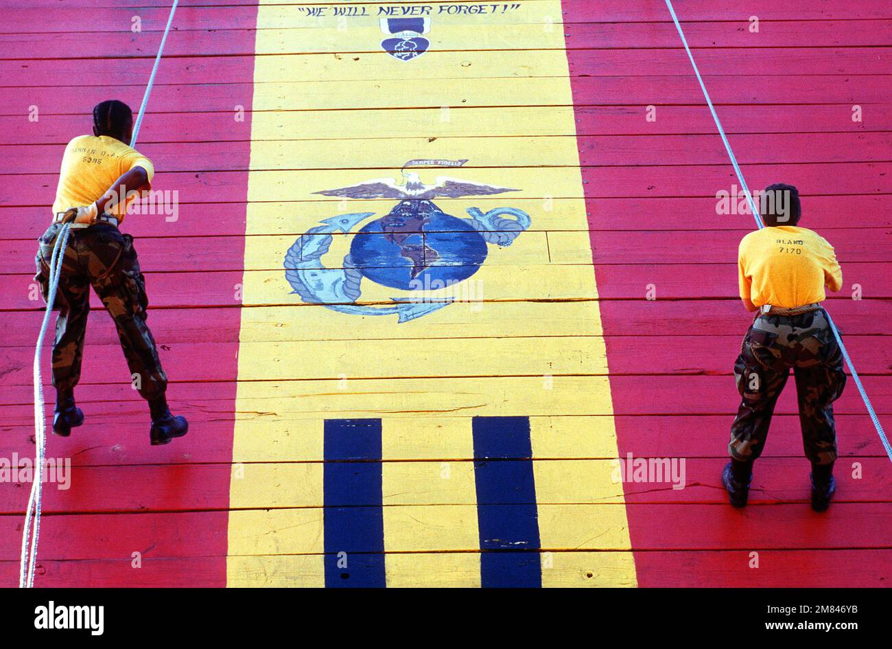 Women Marine recruits rappel down the face of a rappelling tower during ...