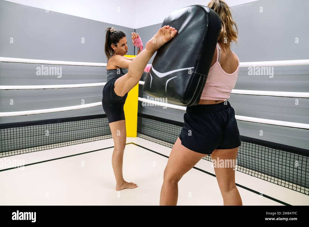 Female kickboxer practicing high kick with her coach in the ring Stock ...
