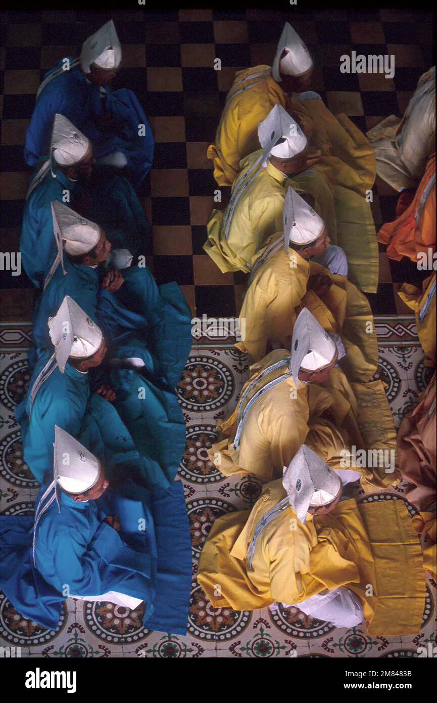 Caodaist disciples, sitting in colorful robes, Cao Dai Holy See Temple ...